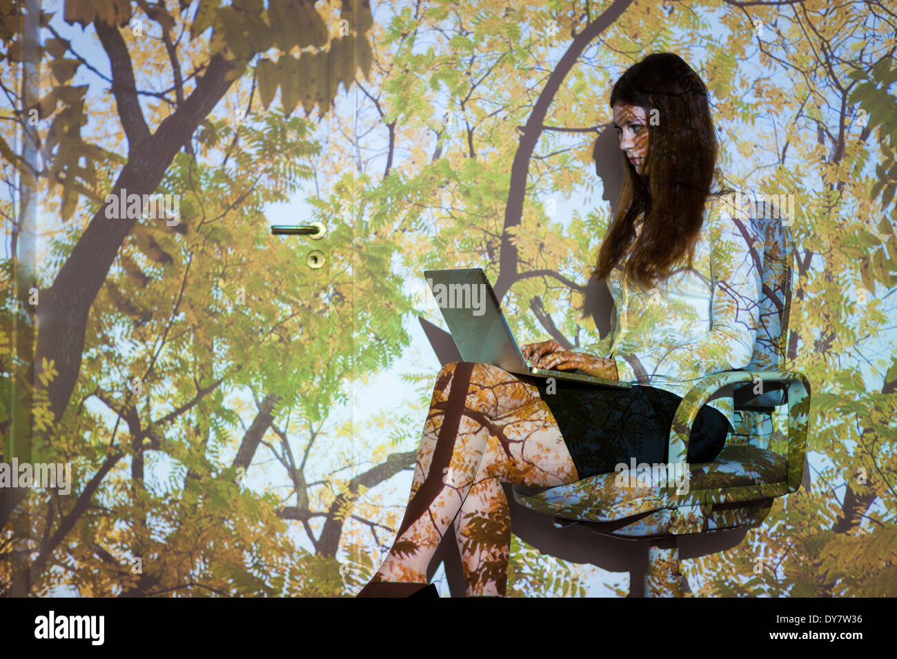 Young woman in nature projection using laptop Stock Photo - Alamy