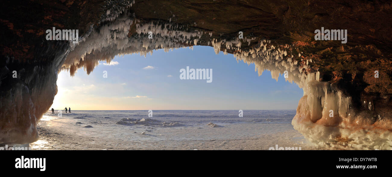 Ice formations and icicles hanging from ceiling in a cave and people ...