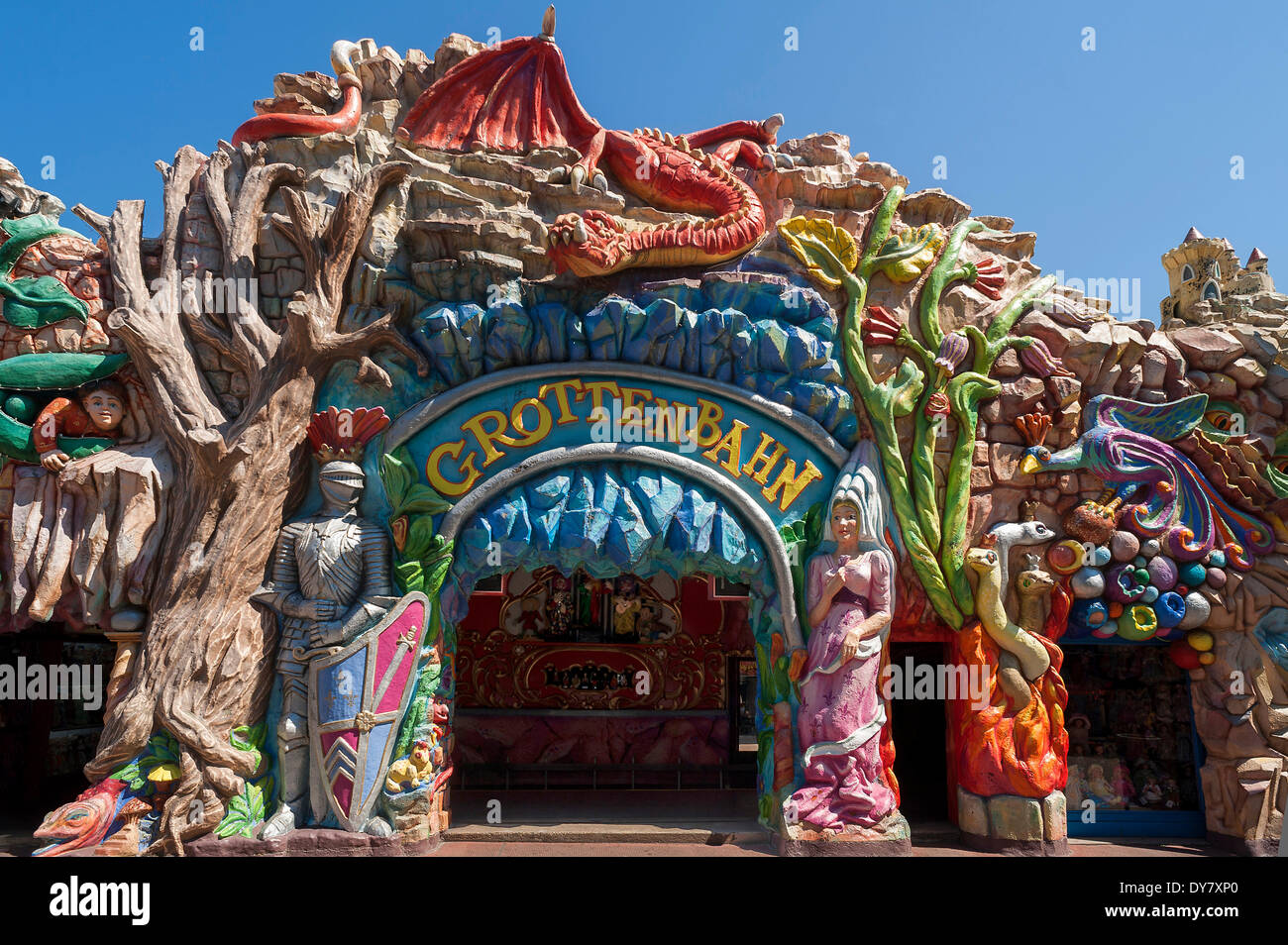 Entrance to the "Grottenbahn" fairground ride decorated with figures ...