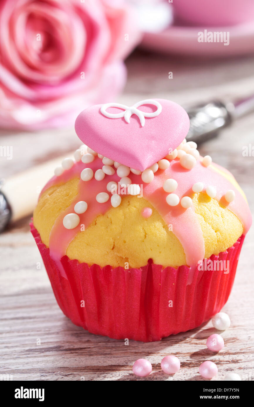 Decorated muffin in muffin paper on laid table Stock Photo - Alamy