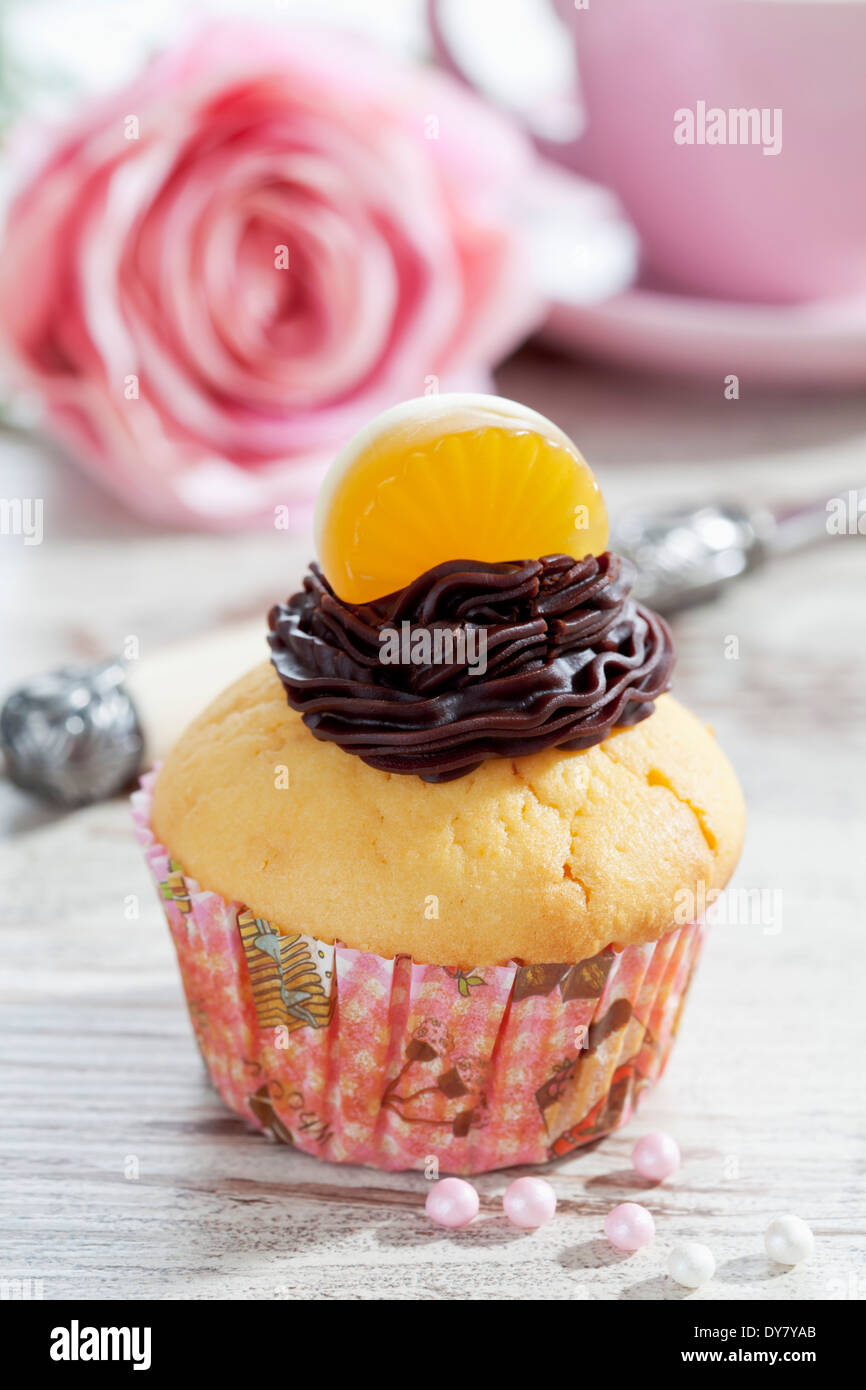 Decorated muffin in muffin paper on laid table Stock Photo - Alamy