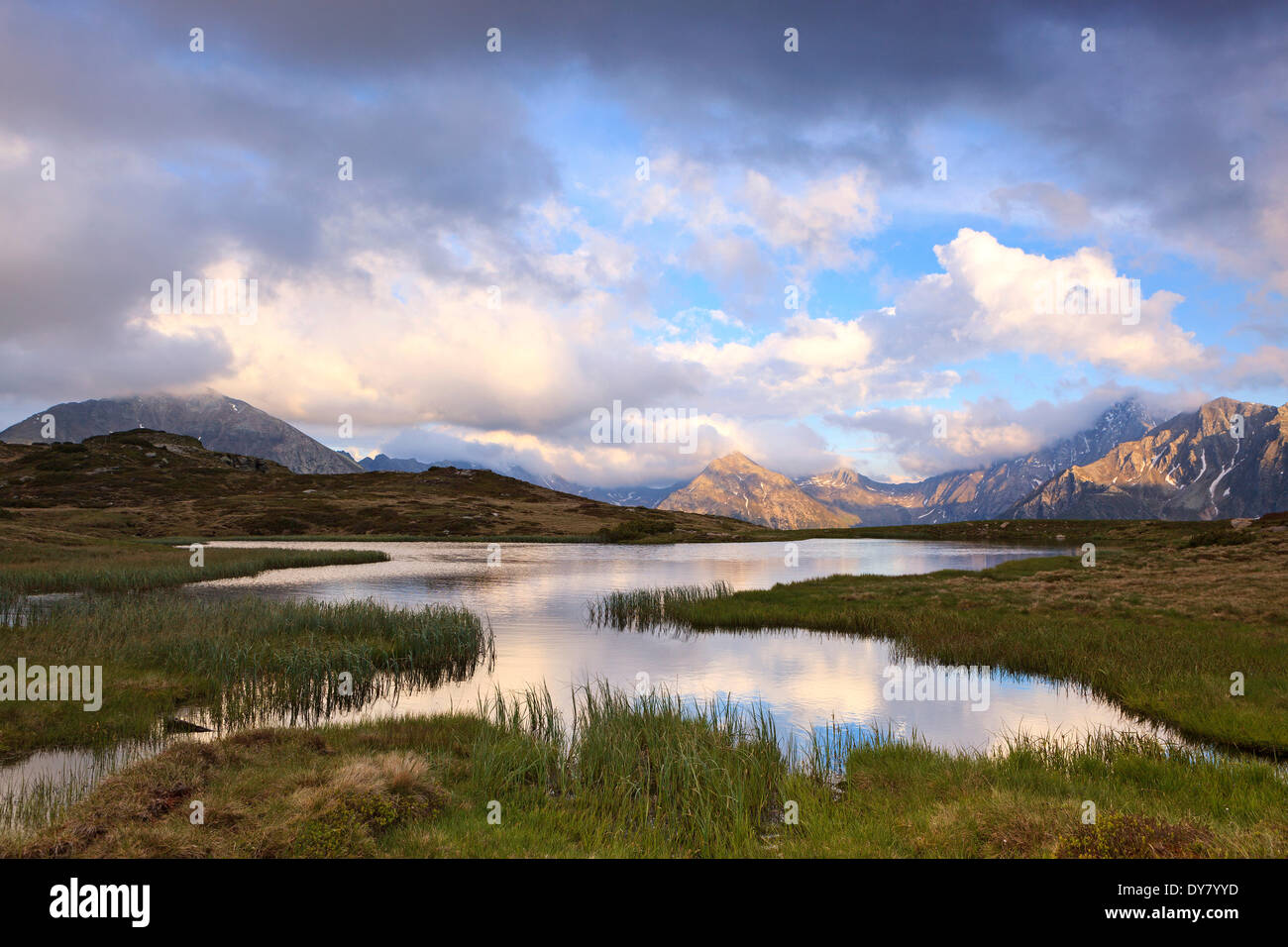 Cloudy sky at Jaufenpass, Passo di Monte Giovo, mountain lake, evening ...