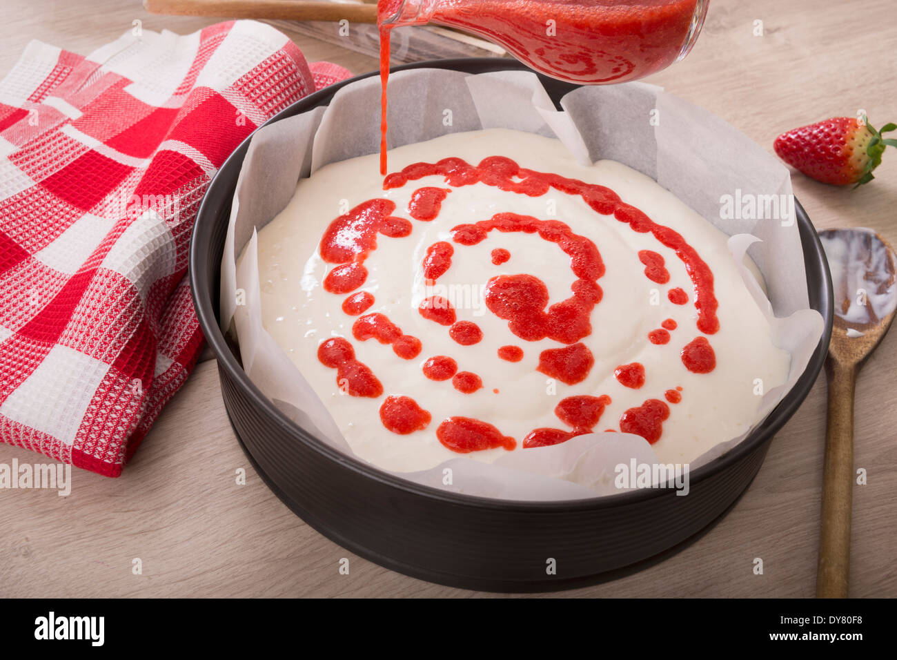 Dripping strawberry puree on cream cheese of cheese cake Stock Photo ...