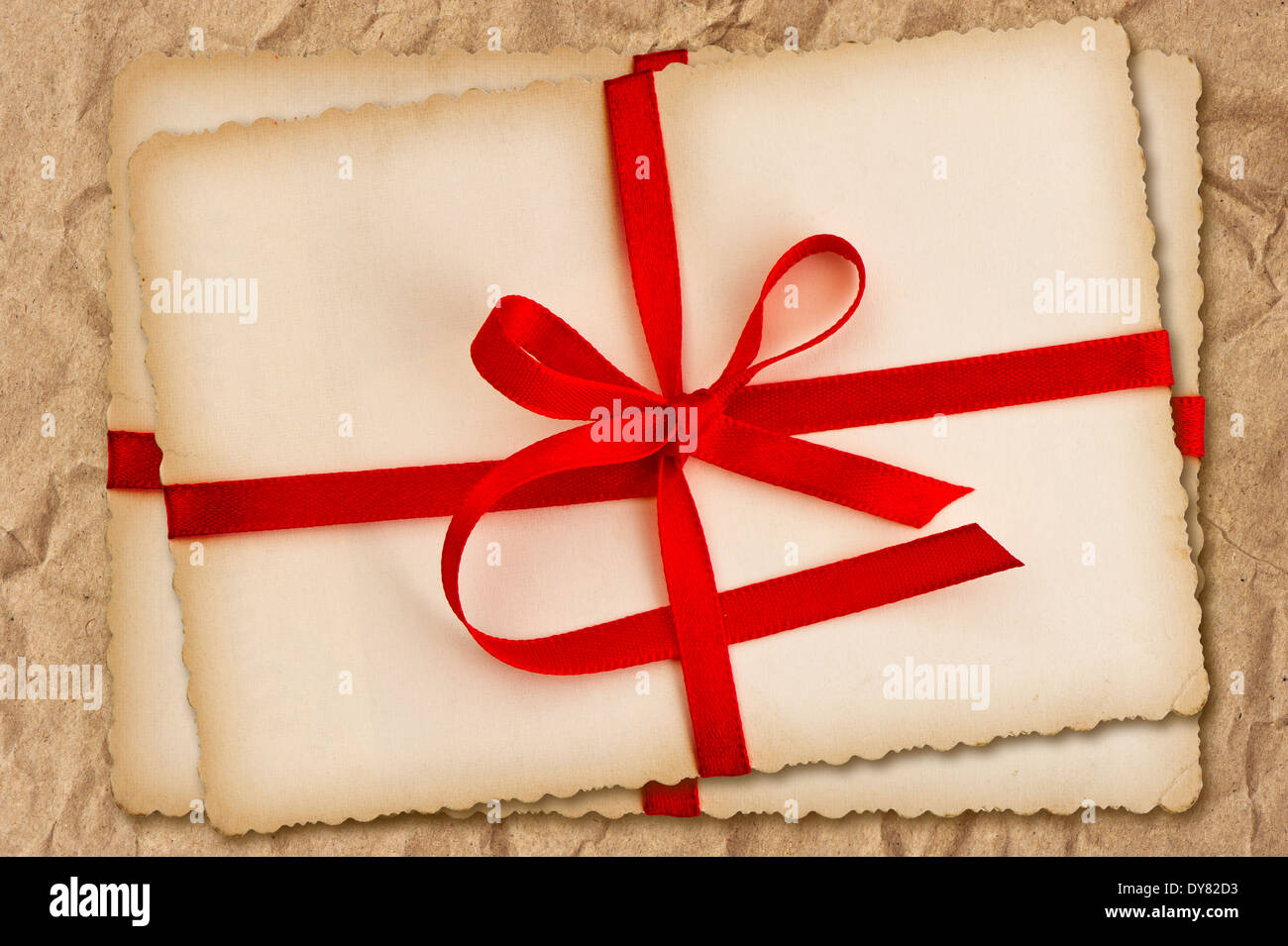 vintage gift card with red ribbon on grunge paper background Stock ...