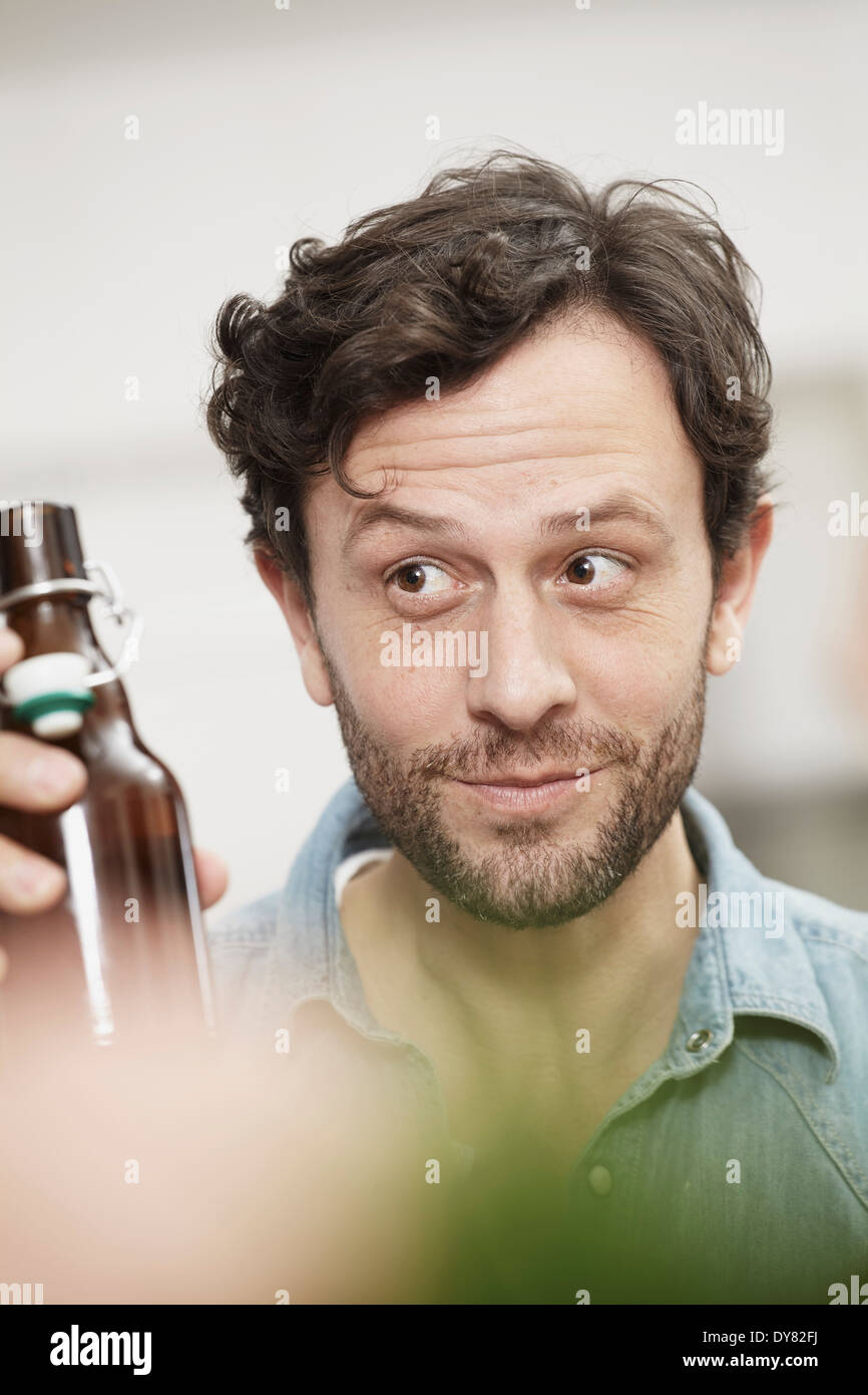 Man holding bottle of beer Stock Photo - Alamy