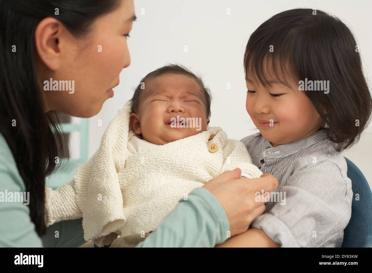 Asian mother with toddler and baby Stock Photo - Alamy