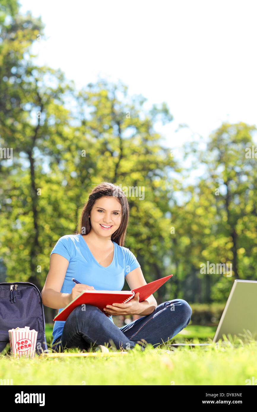 Female student relaxing in park Stock Photo - Alamy