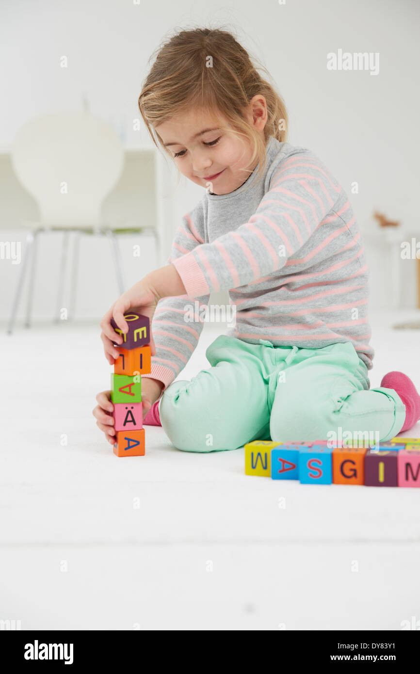 Child playing with letter blocks hi-res stock photography and images ...