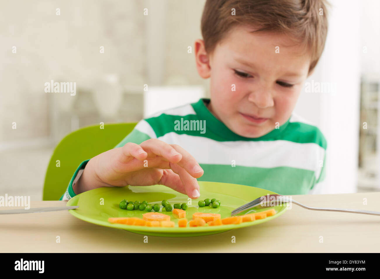 Boy Eating Peas And Carrots High Resolution Stock Photography and ...