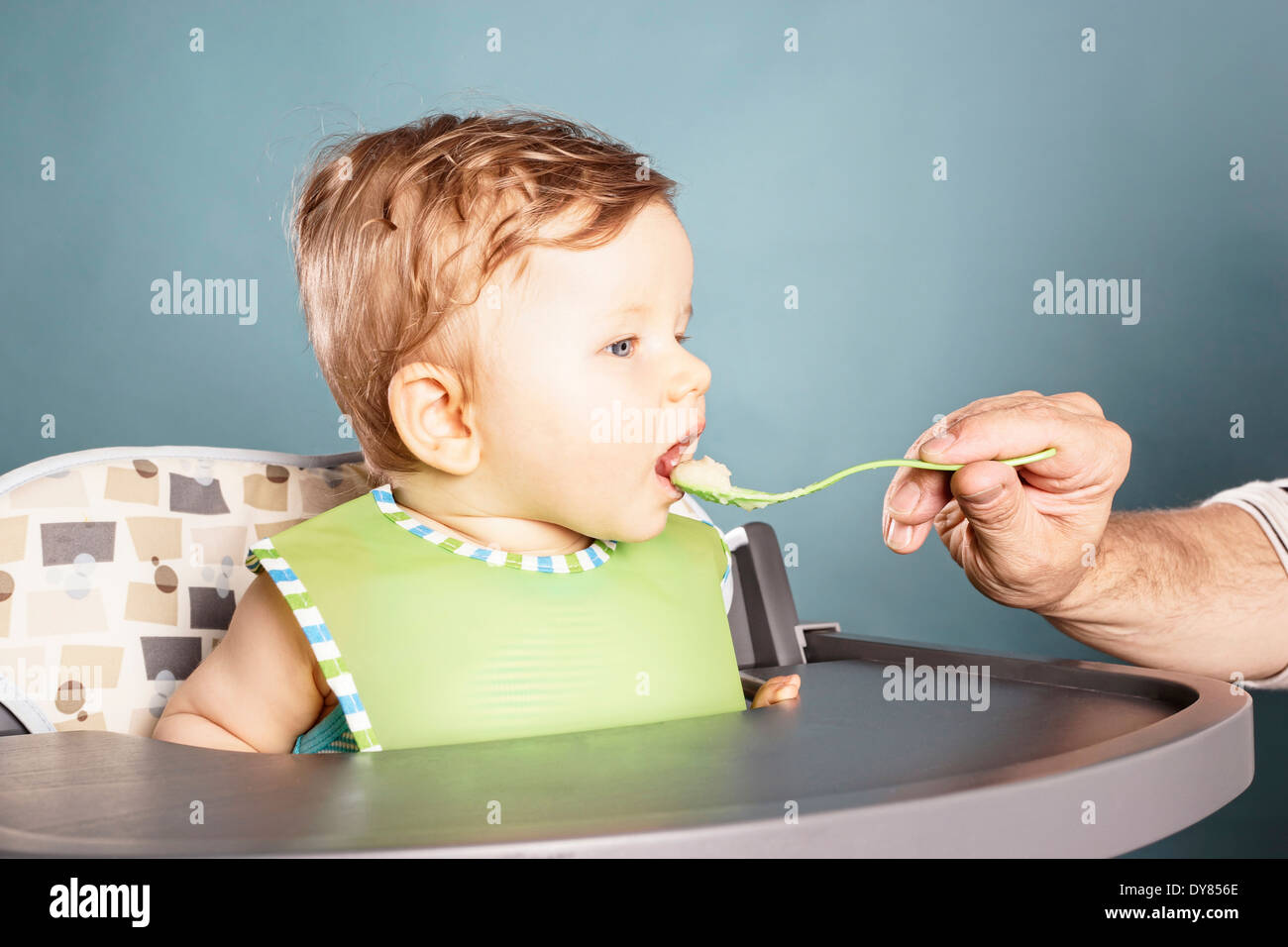 Baby being fed high chair hi-res stock photography and images - Alamy