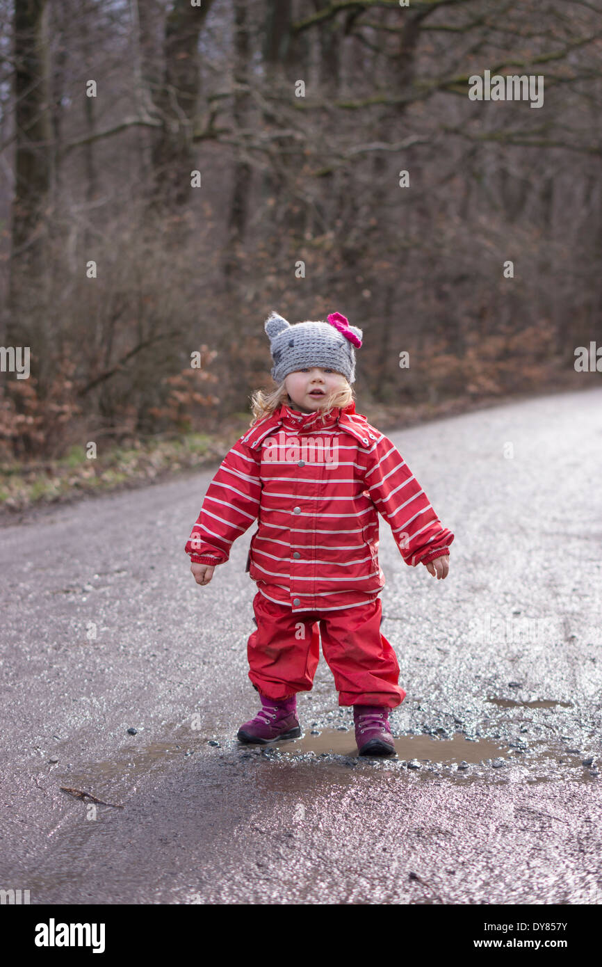 Toddler standing in a puddle Stock Photo - Alamy