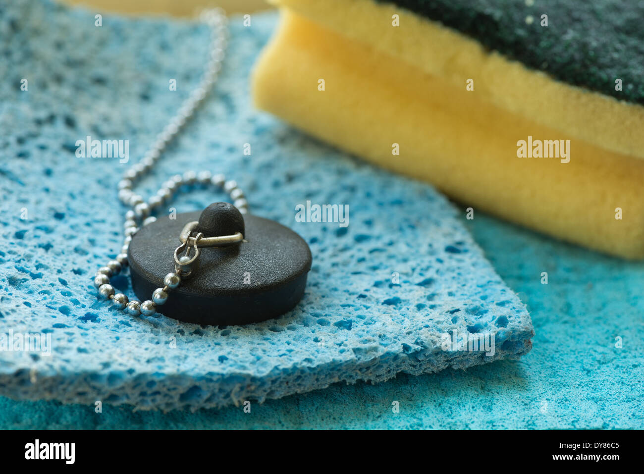 Daily washing up chores cleaning cutlery with sponge scourer and plug ...