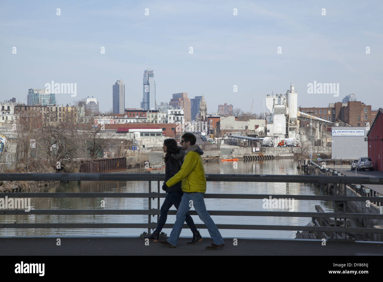Two people walk on the 9th street bridge over the polluted Gowanus ...