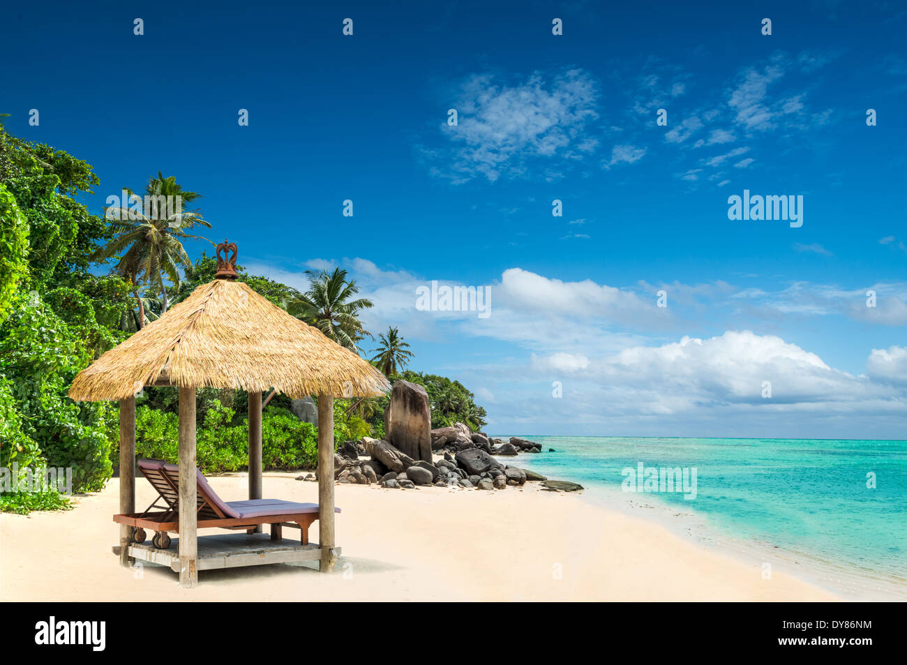 beach beds with roof and turquoise sea Stock Photo - Alamy
