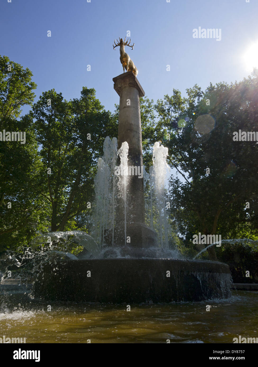 Germany, Berlin, fountain and sculpture of golden deer at park in ...