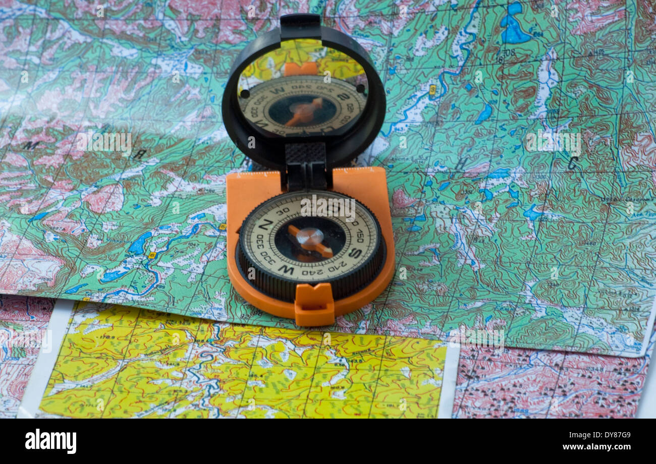 Magnetic compass in a red-black housing, equipped with a mirror, is on ...