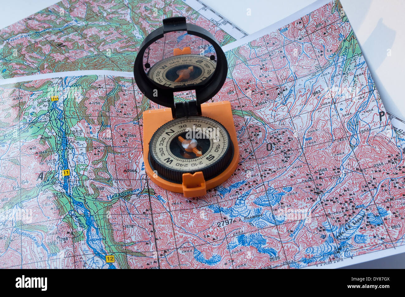 Magnetic compass in a red-black housing, equipped with a mirror, is on ...
