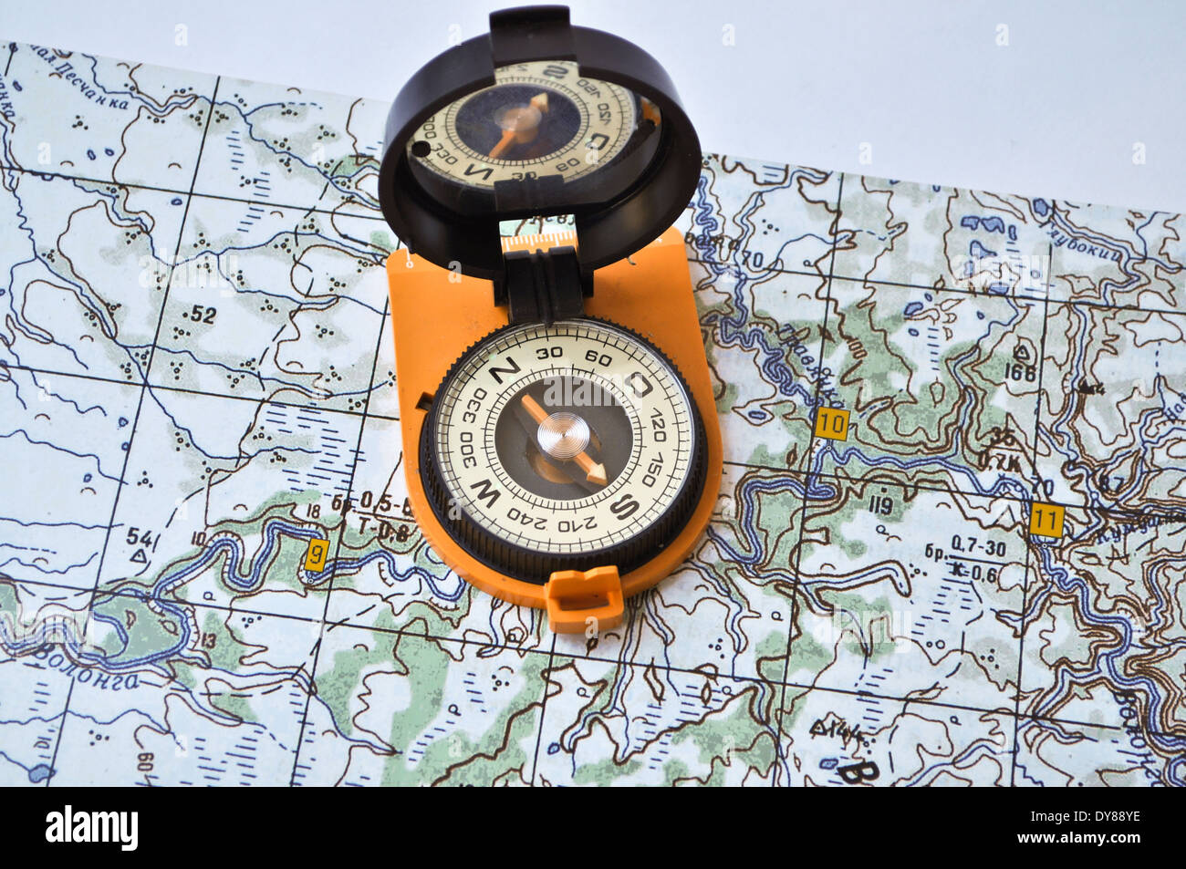 Topographic map lies on a white background, and there is a magnetic ...