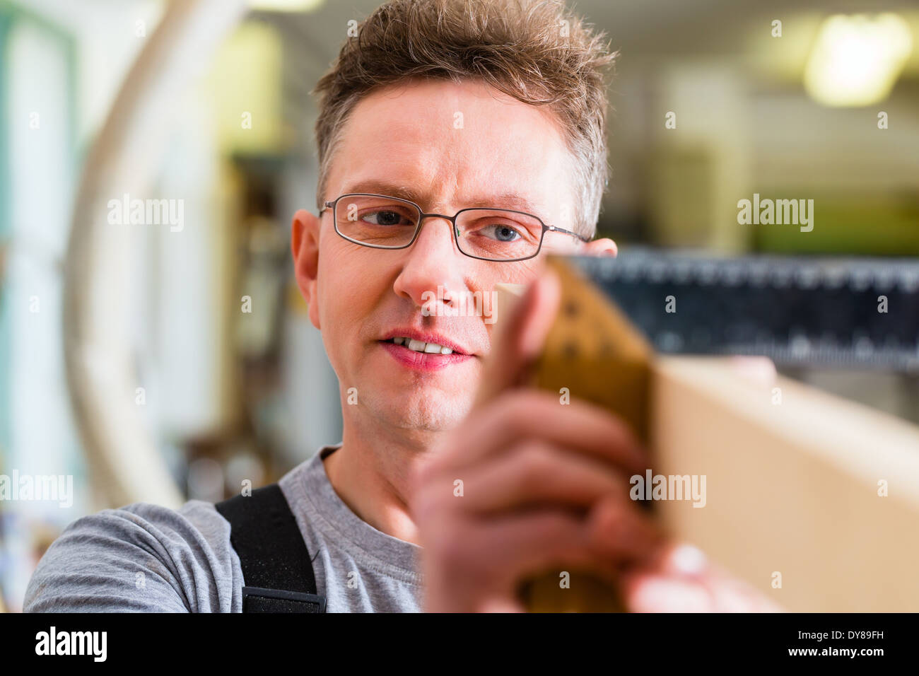 Carpenter working with angle in his workshop or carpentry Stock Photo ...