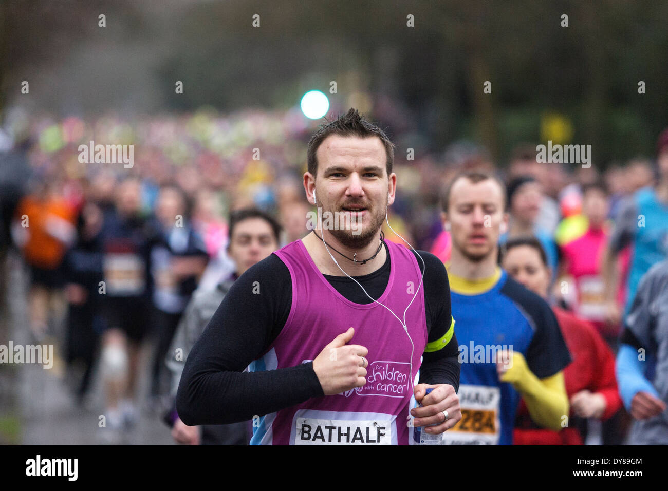 A male runner listening to music takes part in the 2013 Bath half ...