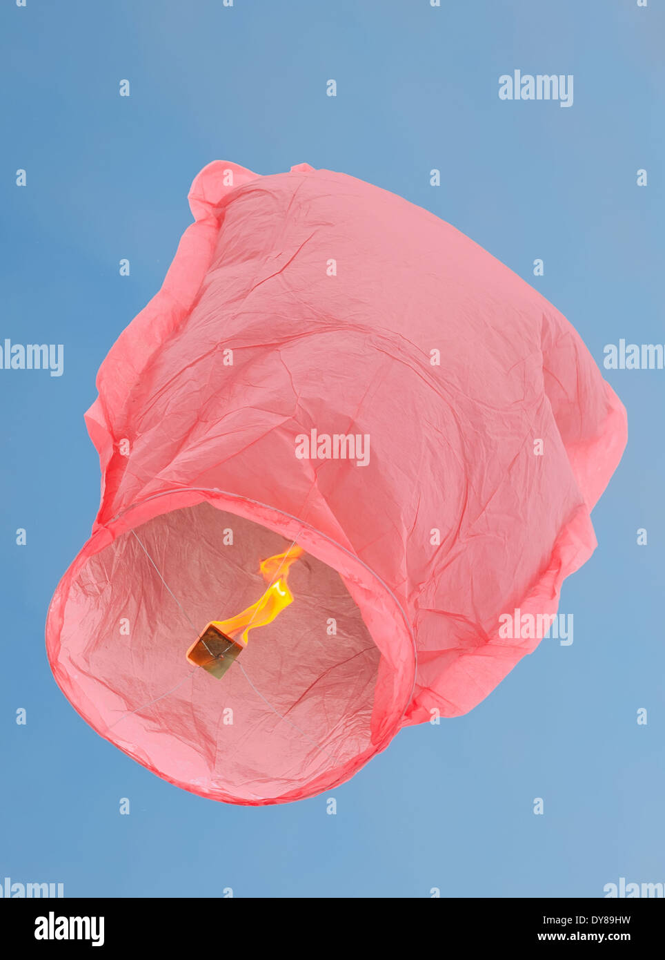 Single Floating Lantern flies in the blue sky Stock Photo - Alamy