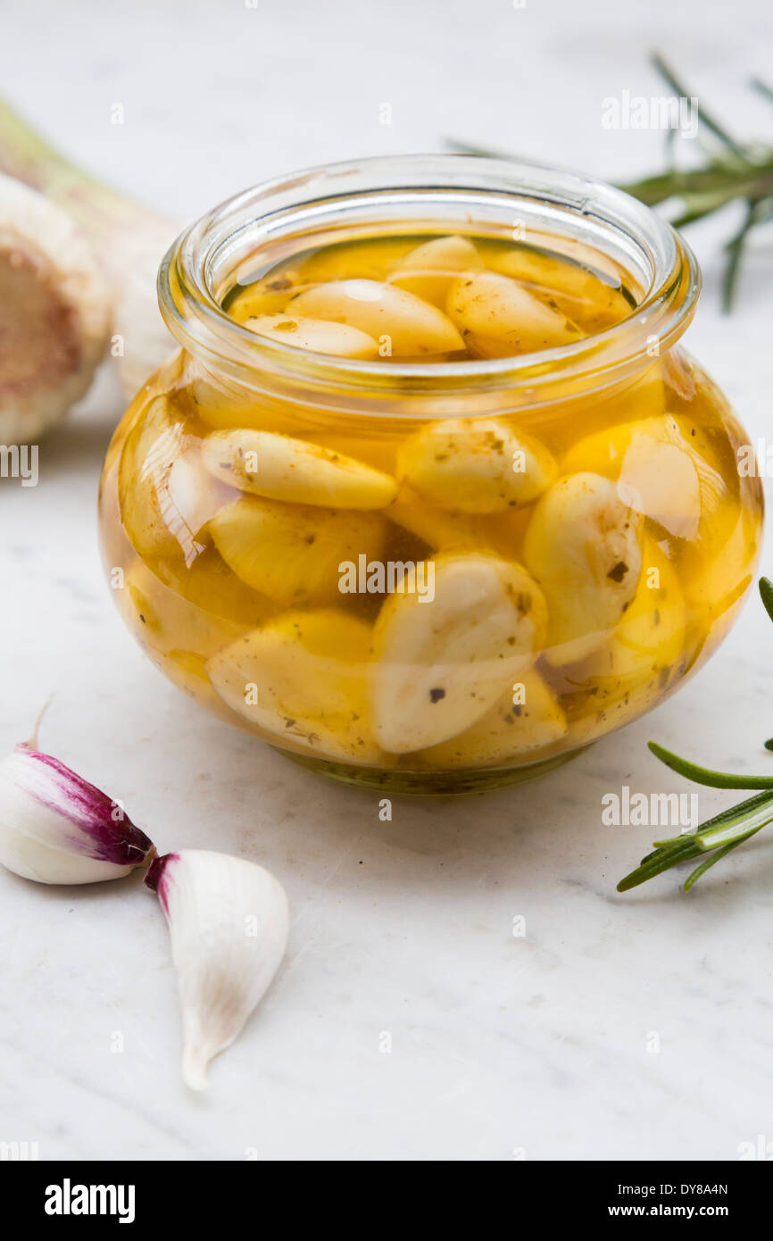 Fresh and pickled garlic cloves on white marble Stock Photo - Alamy