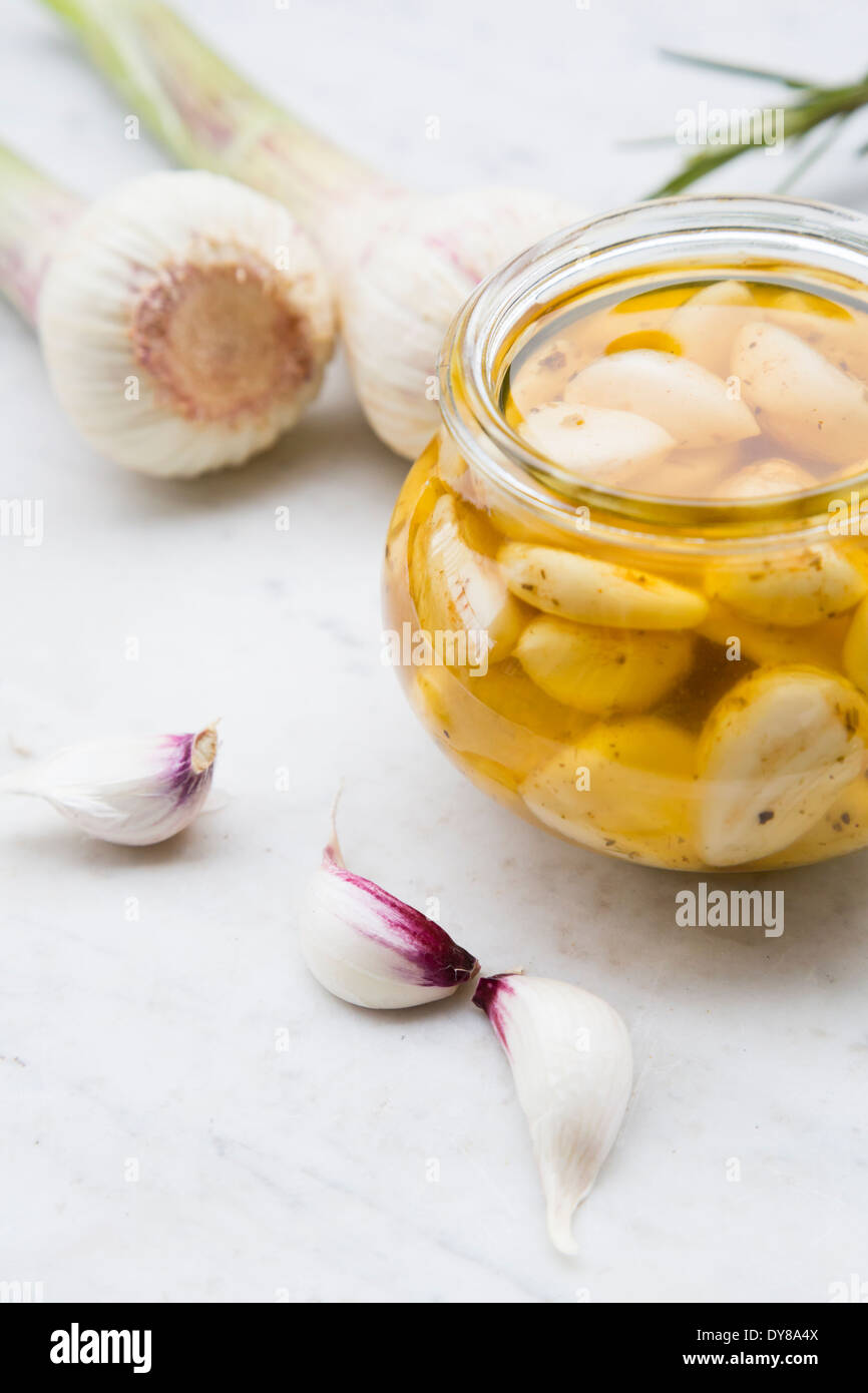 Fresh and pickled garlic cloves on white marble Stock Photo - Alamy
