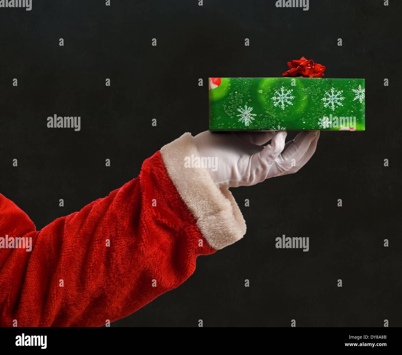Santa Father Christmas hand with wrapping paper present and red star ...