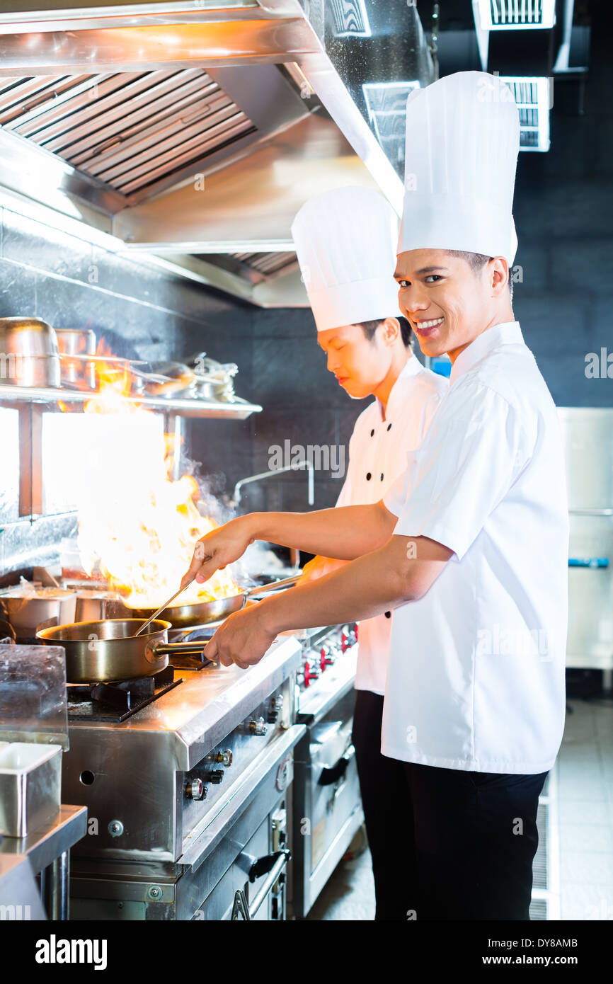 Side view of chefs cooking together Stock Photo - Alamy