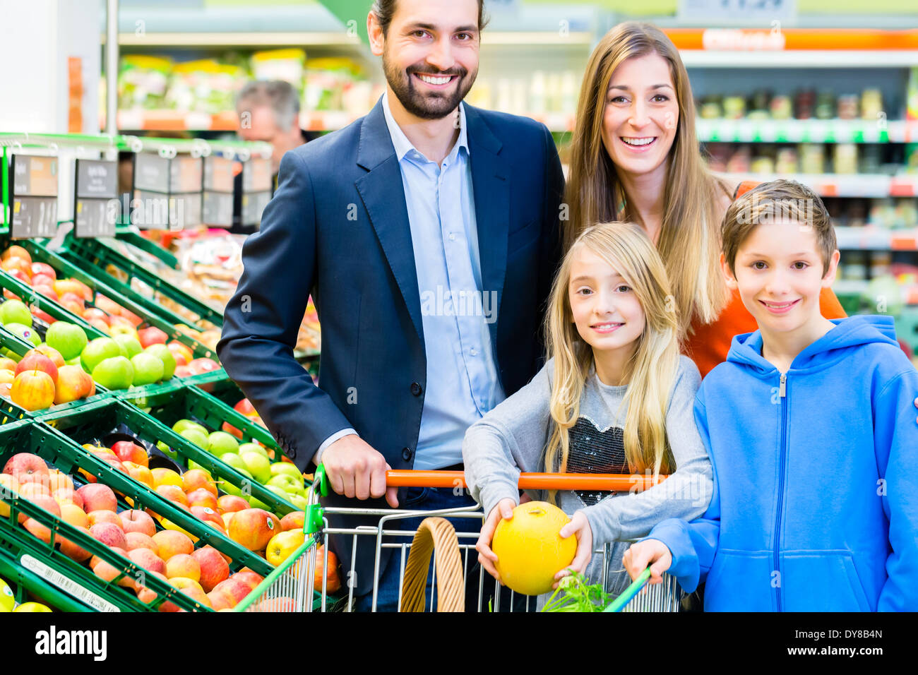 Family in supermarket selecting fruits while grocery shopping Stock ...