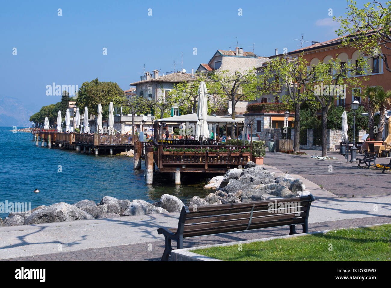 promenade along the lake in torri del benaco village, lake garda, italy ...