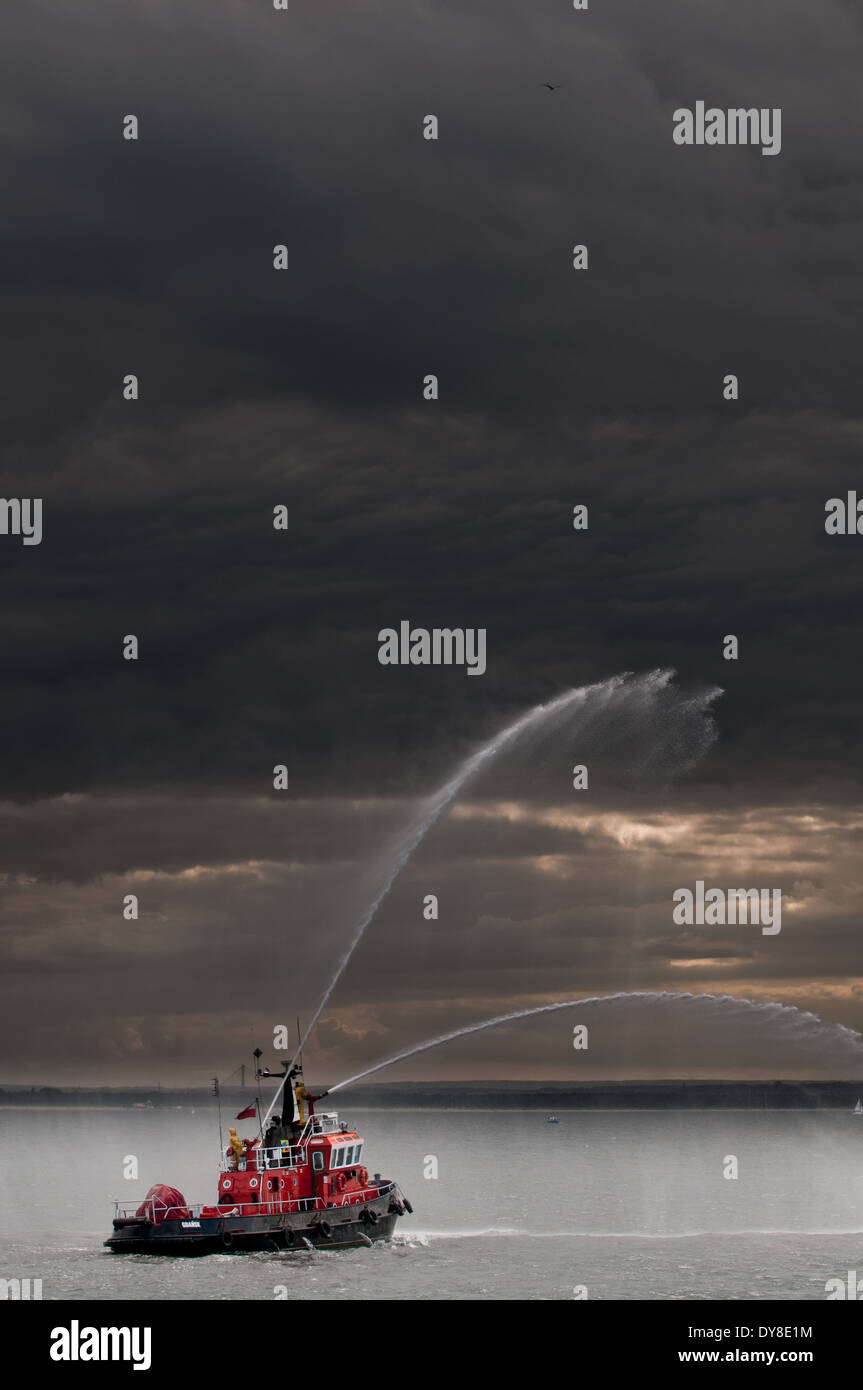 small fireboat demonstrating its capabilities on Baltic Sea in Gdansk ...