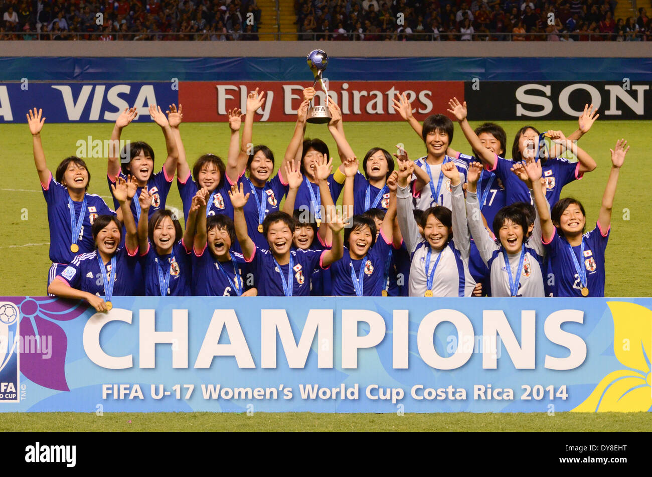 Japan squad in National Stadium pitch, posing with Champions medals and ...