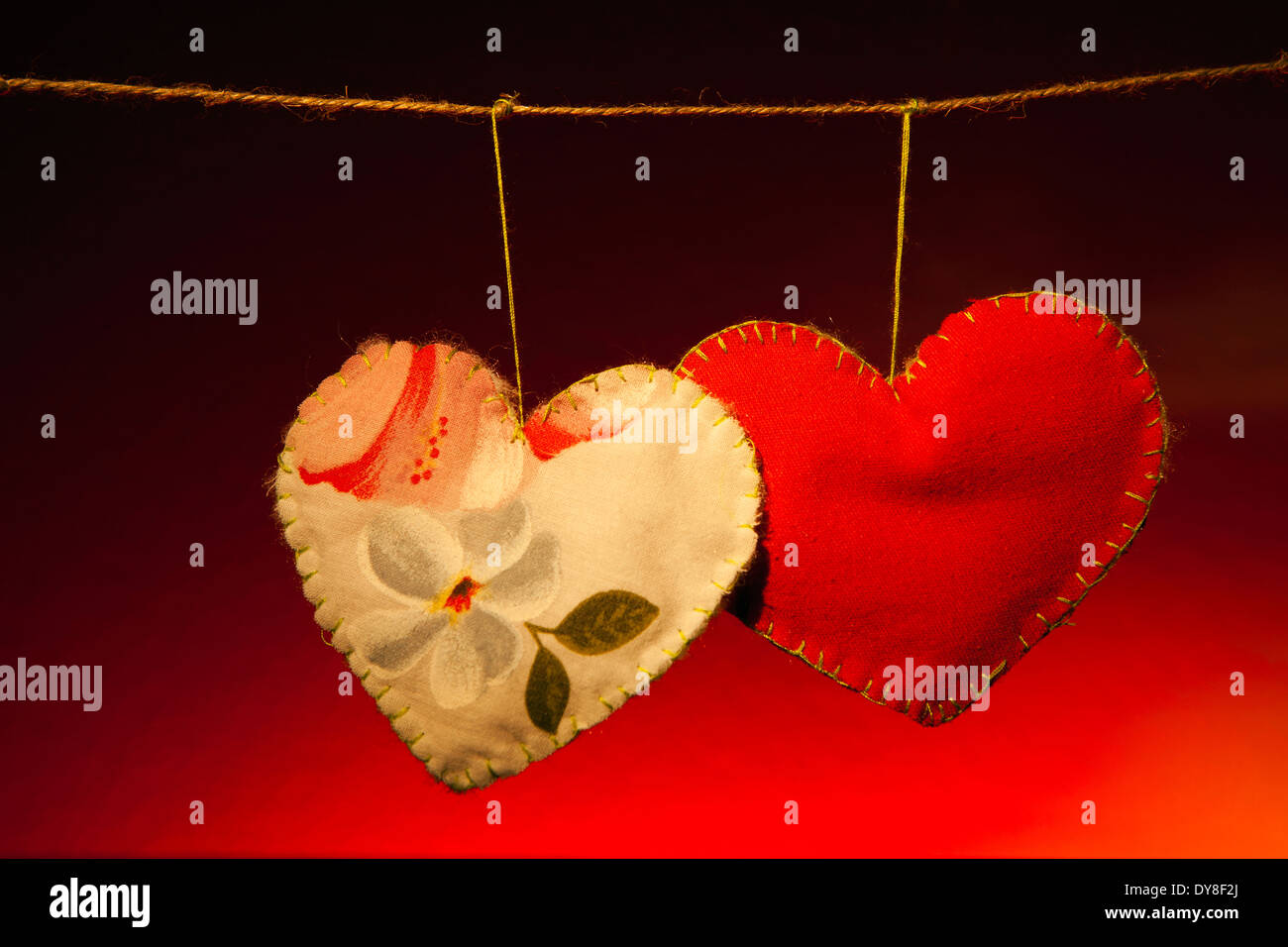 Cotton fabric hearts on the red background Stock Photo - Alamy