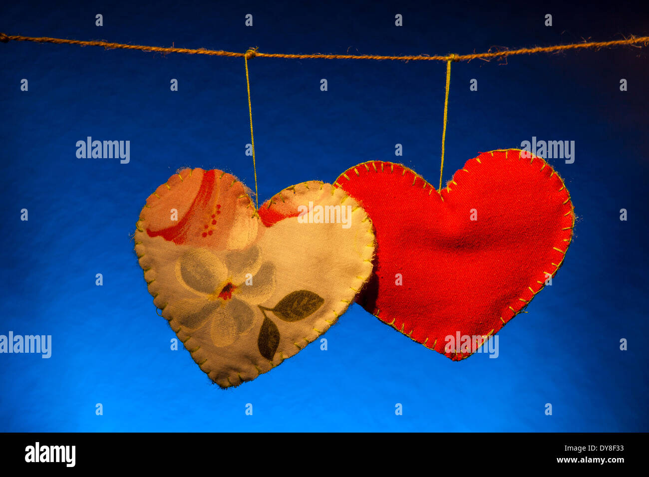 Cotton fabric hearts on the blue background Stock Photo - Alamy