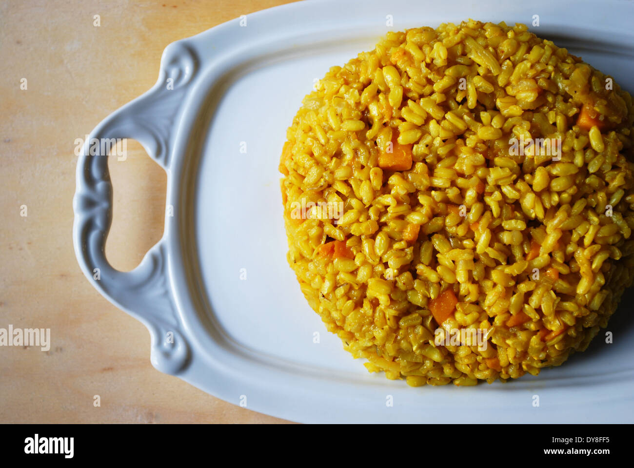 Pumpkin risotto made with brown rice, onion and curry served on white ...