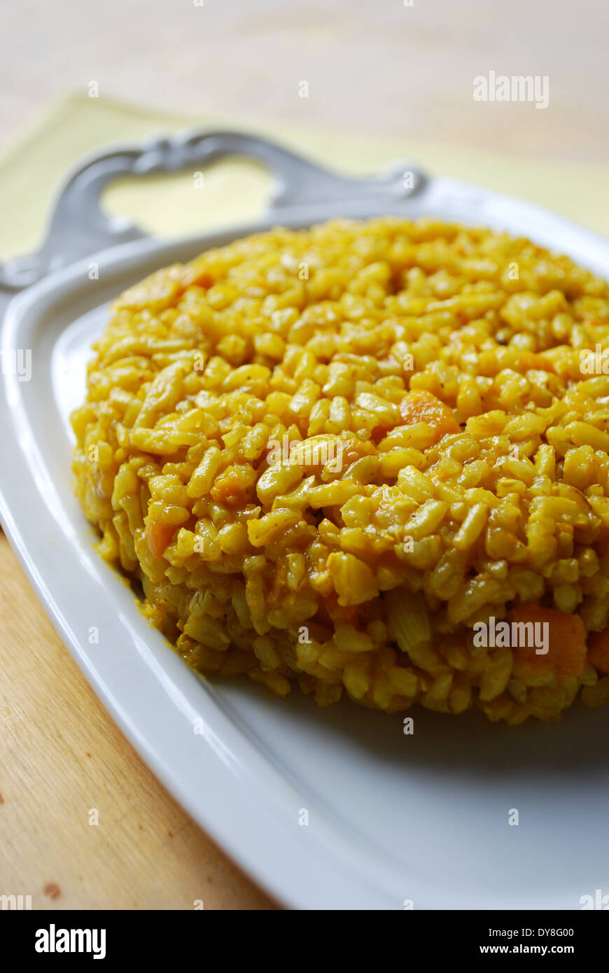 Pumpkin risotto made with brown rice, onion and curry served on white ...