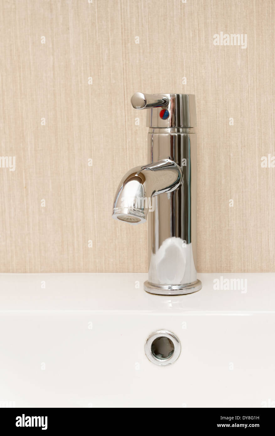 Monobloc bathroom tap on white basin Stock Photo - Alamy