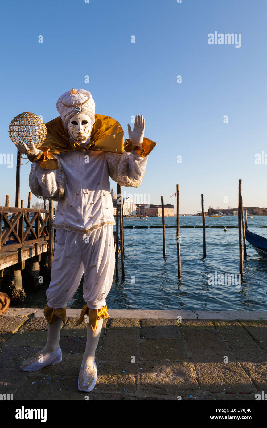 Venice carnival, portrait of costumed jester magician in white fancy ...