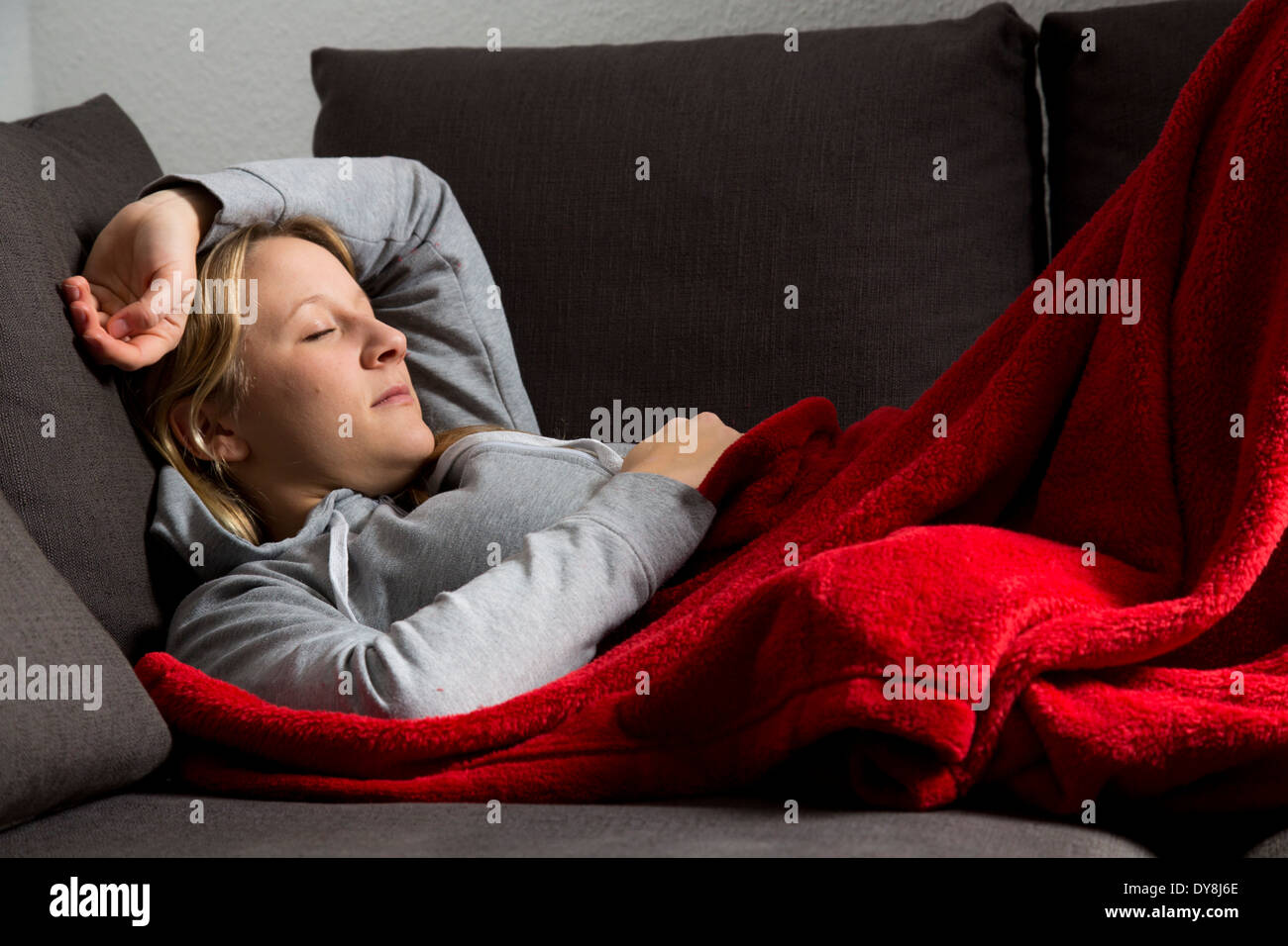Young woman feels uncomfortable, has a cold, flu, pain Stock Photo - Alamy