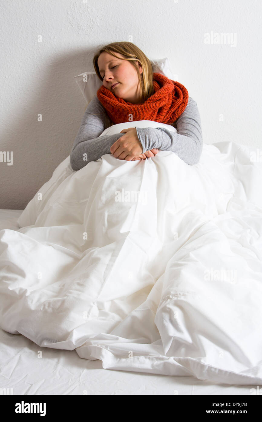 Young woman feels uncomfortable, has a cold, flu, lying in bed Stock ...