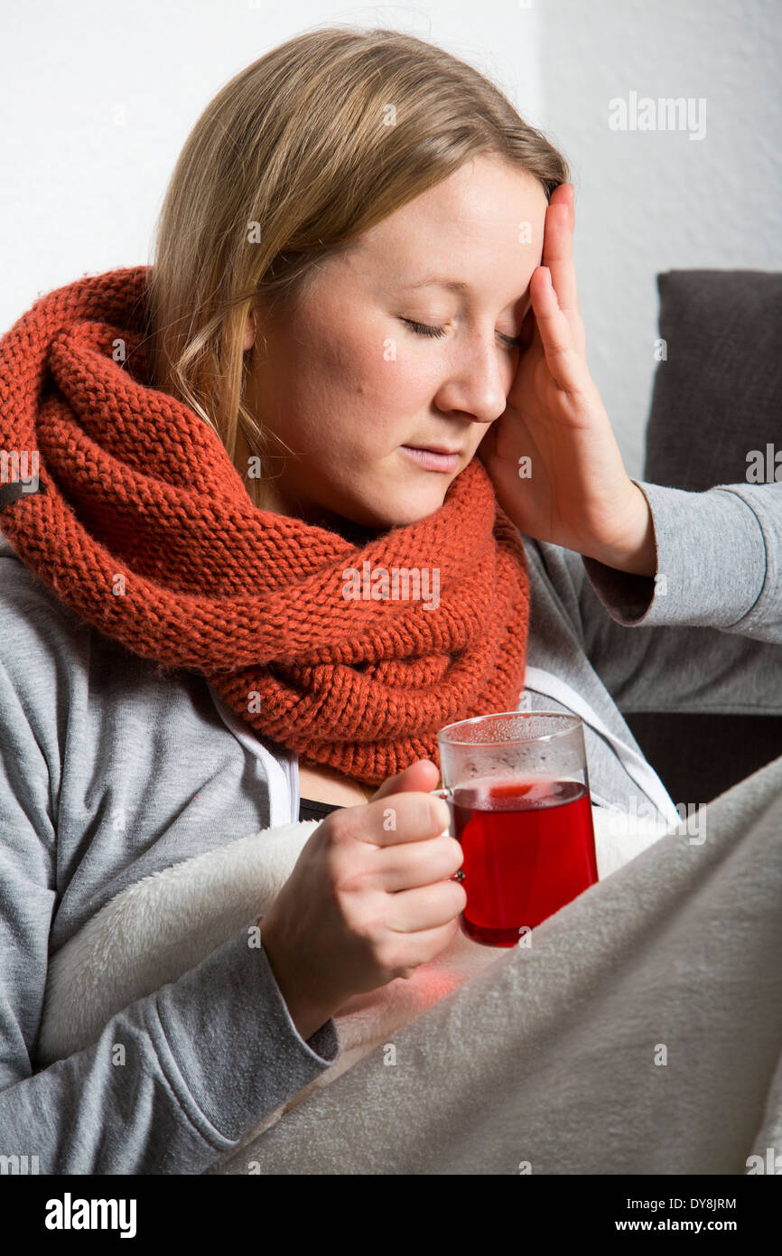 Young woman has a cold, drinking a hot tea Stock Photo - Alamy