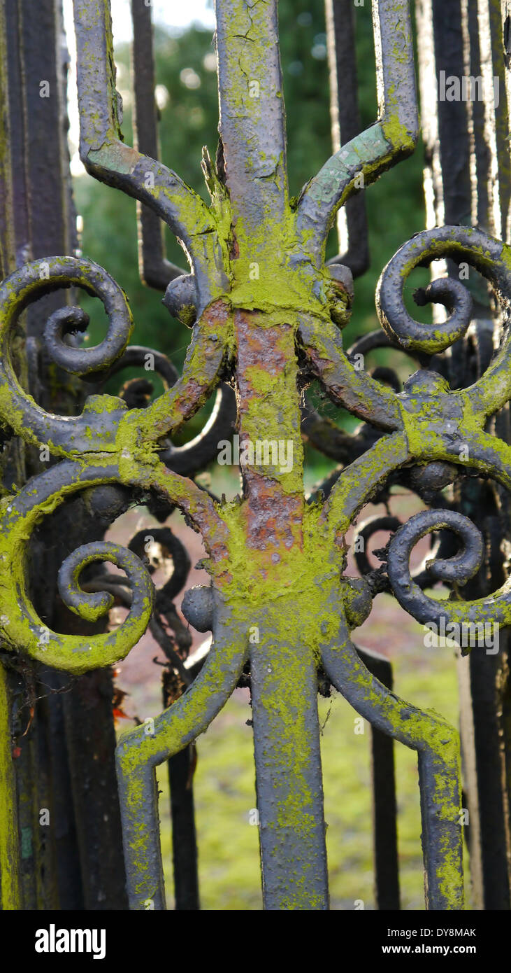 Partial view of abandoned, derelict and rusting wrought iron gate ...