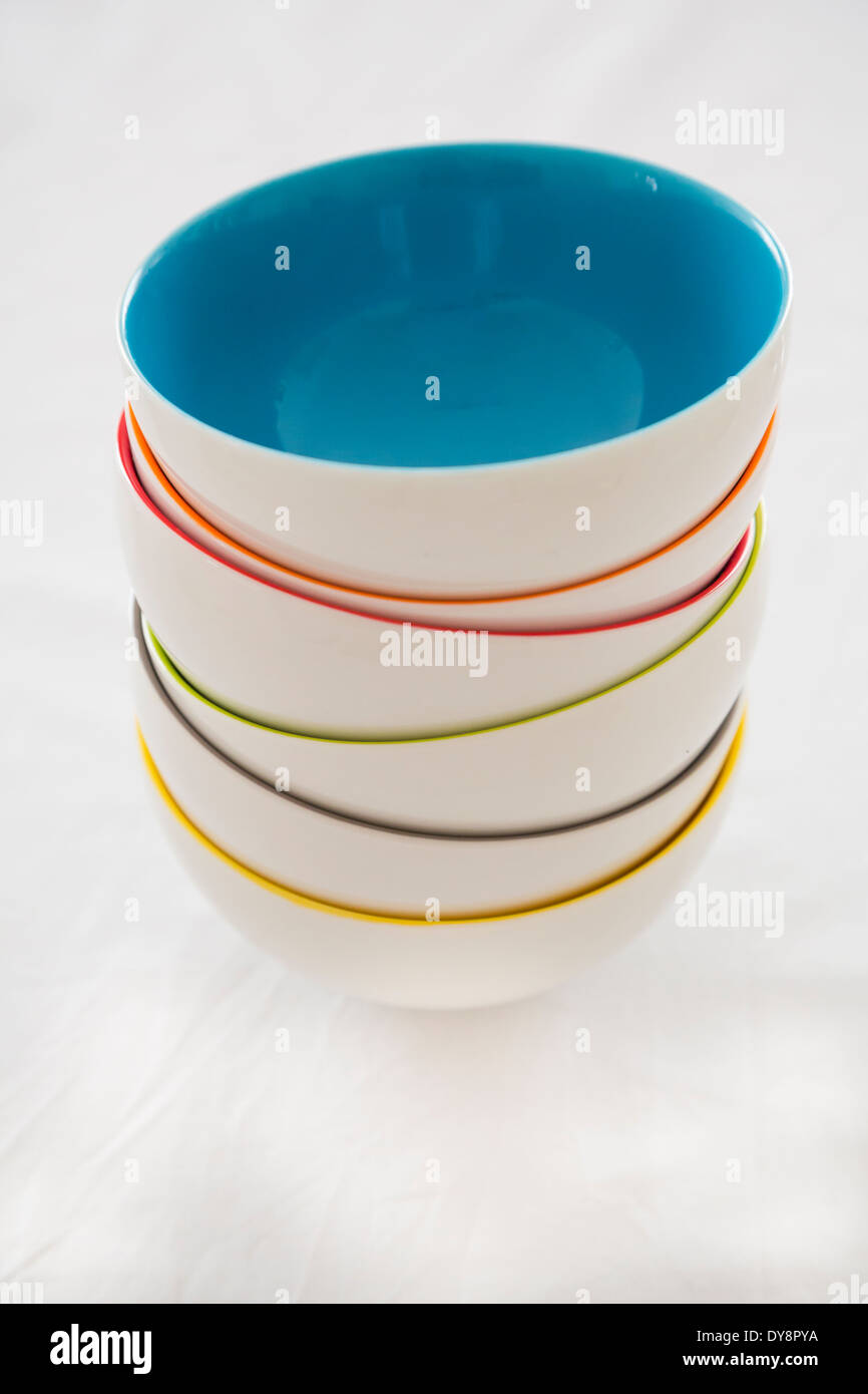 Stack of six coloured bowls on white background Stock Photo - Alamy