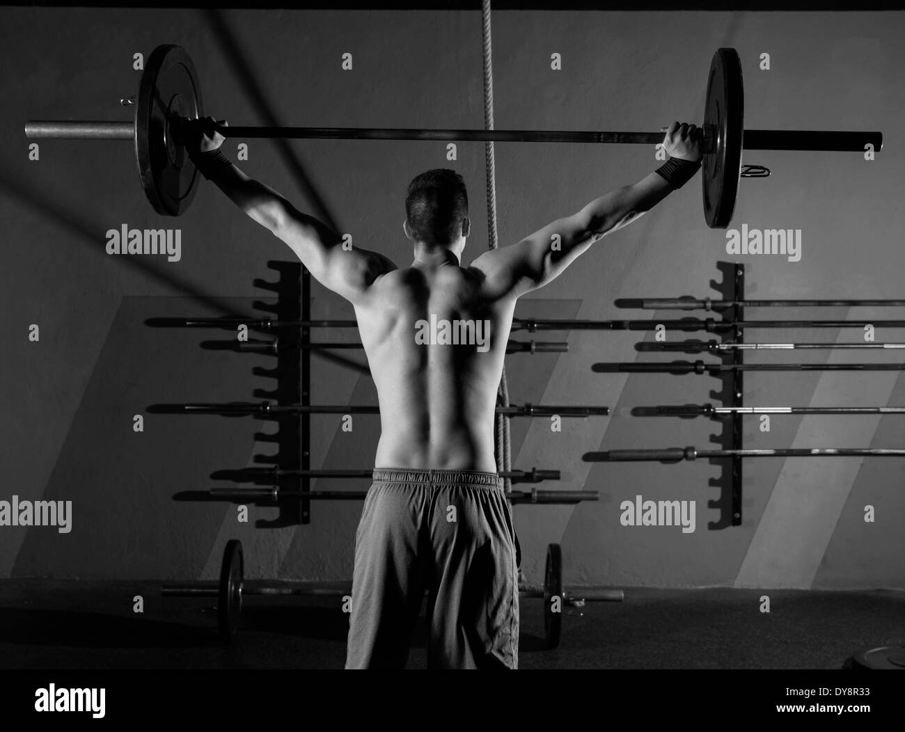 barbell weight lifting man rear view back workout exercise at gym box ...
