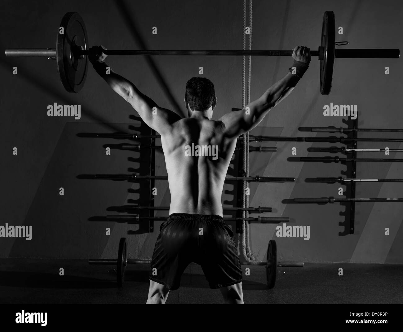barbell weight lifting man rear view back workout exercise at gym box ...