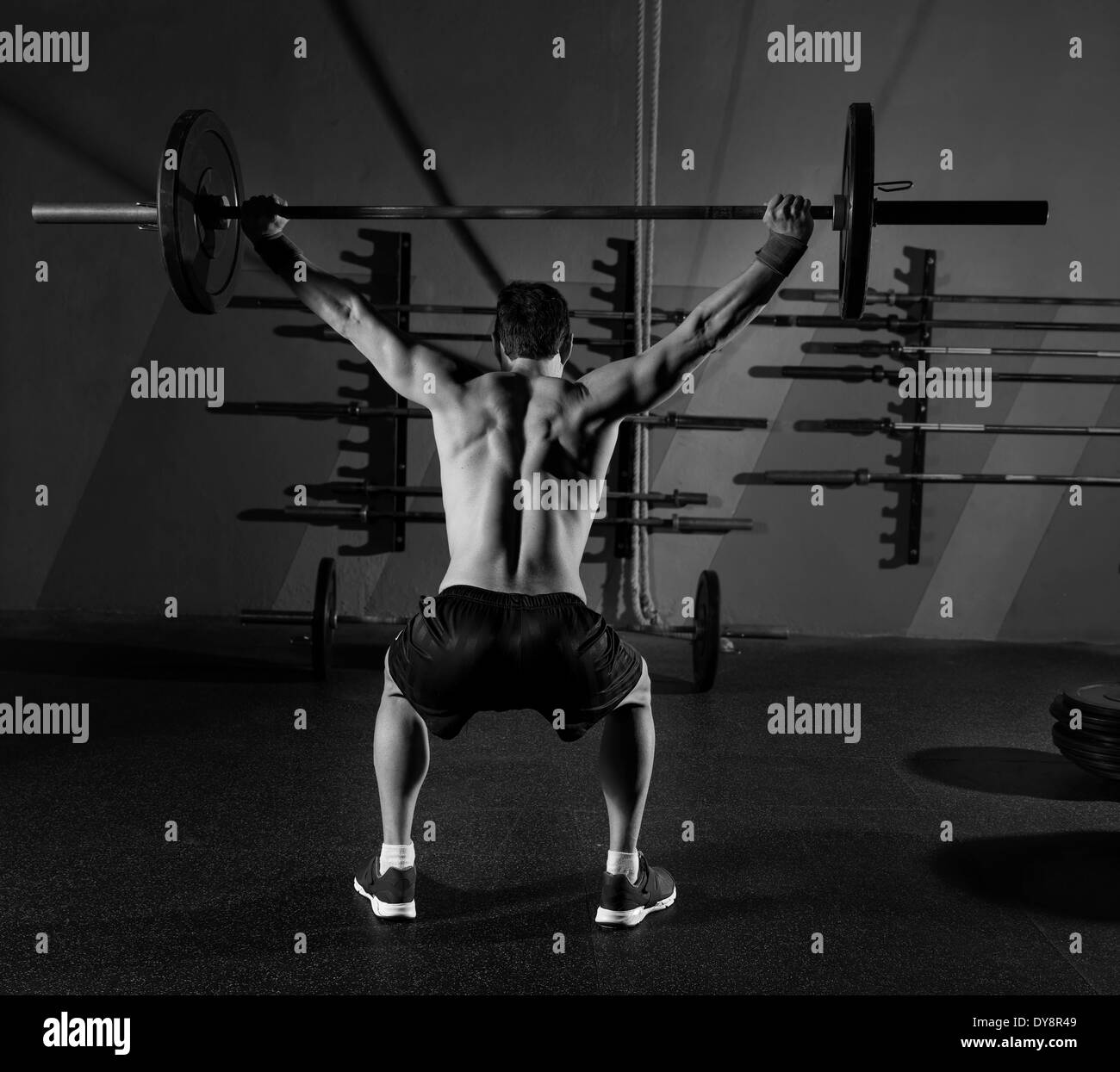 barbell weight lifting man rear view back workout exercise at gym box ...