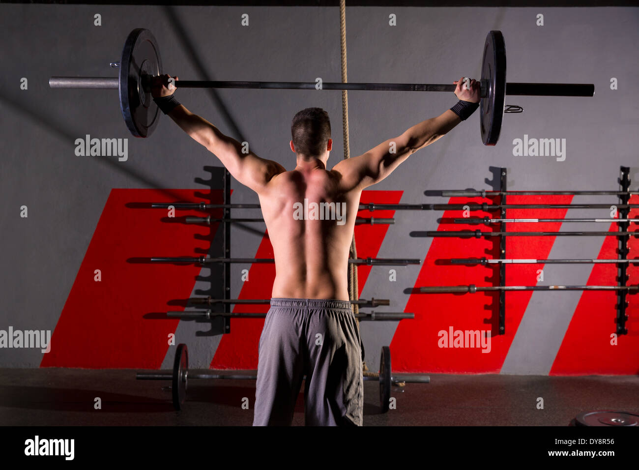 barbell weight lifting man rear view back workout exercise at gym box ...