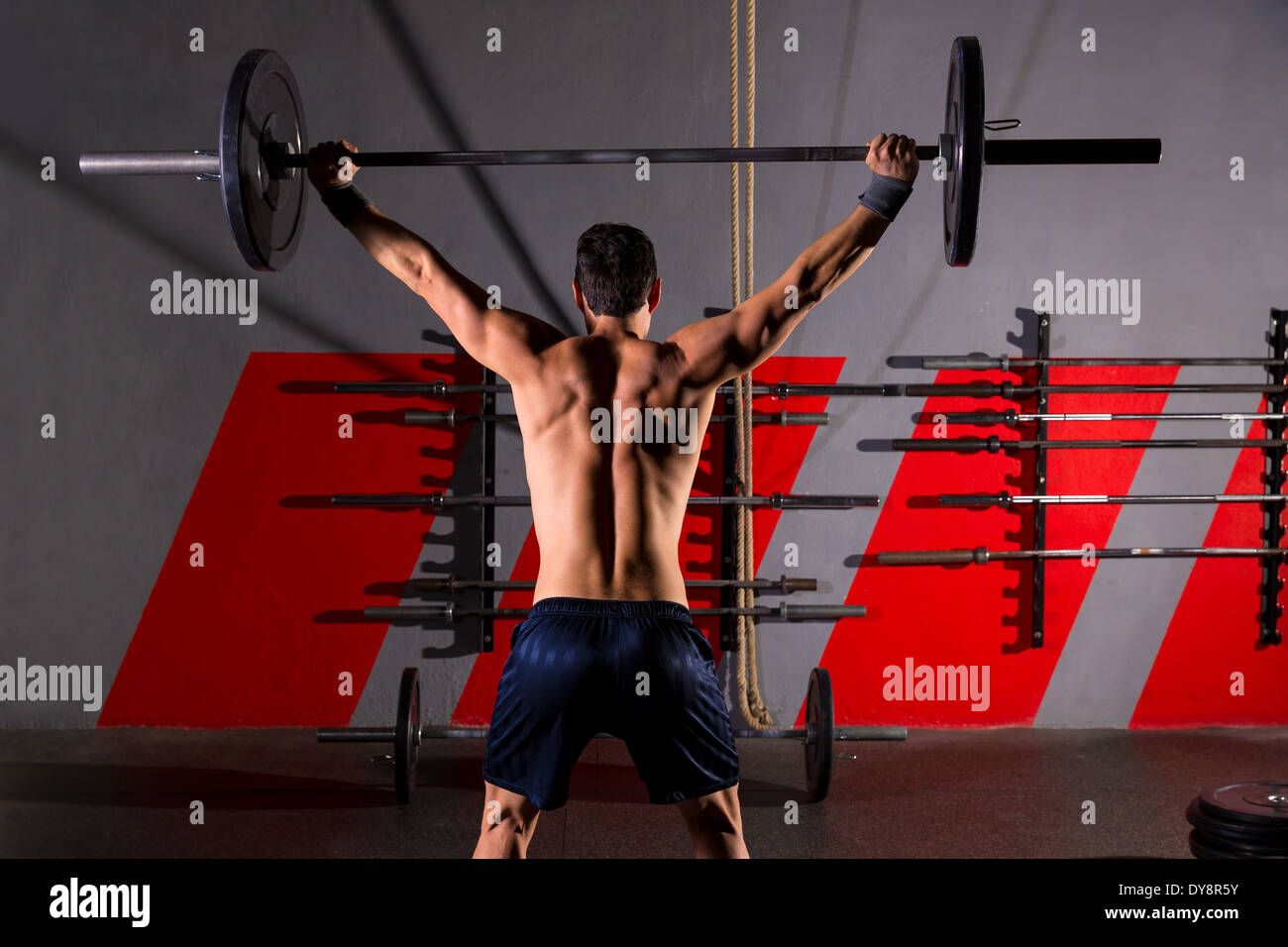 barbell weight lifting man rear view back workout exercise at gym box ...