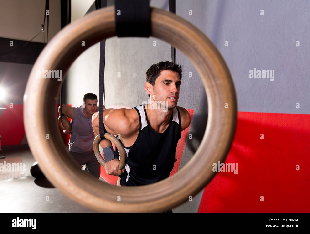 Male gymnast hanging from rings hi-res stock photography and images - Alamy